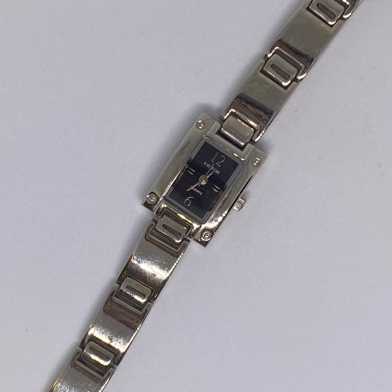 Victor Silver tone watch with rectangle black face.... - Depop