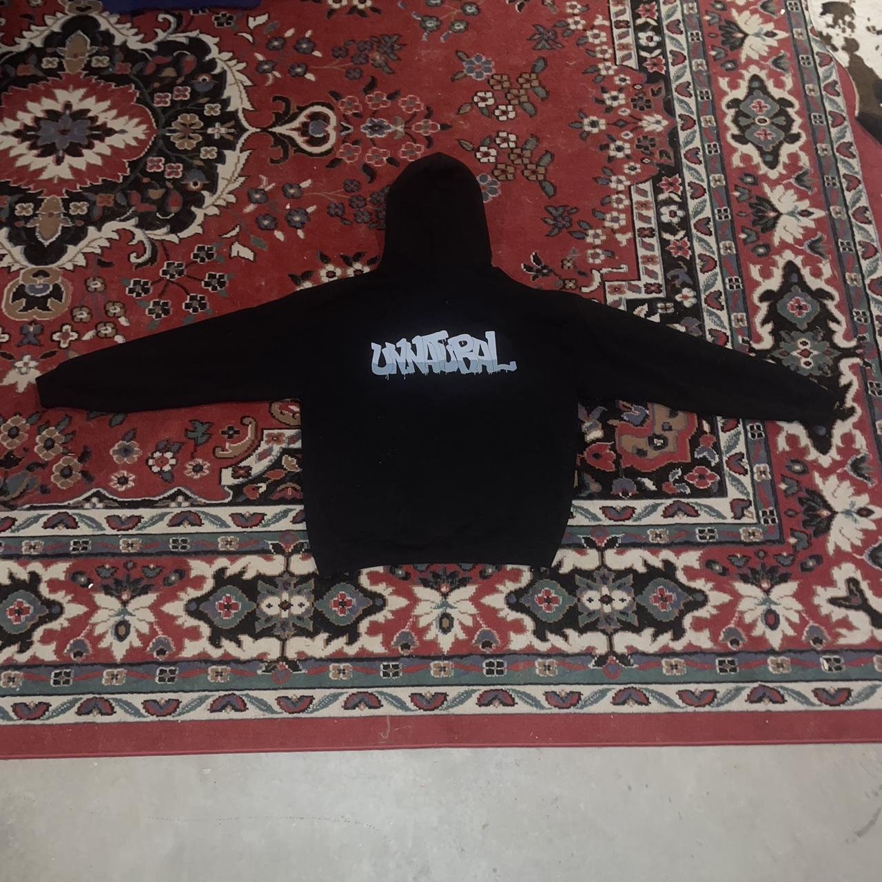 Black hoodie with graffiti font Text reads: unnatural - Depop