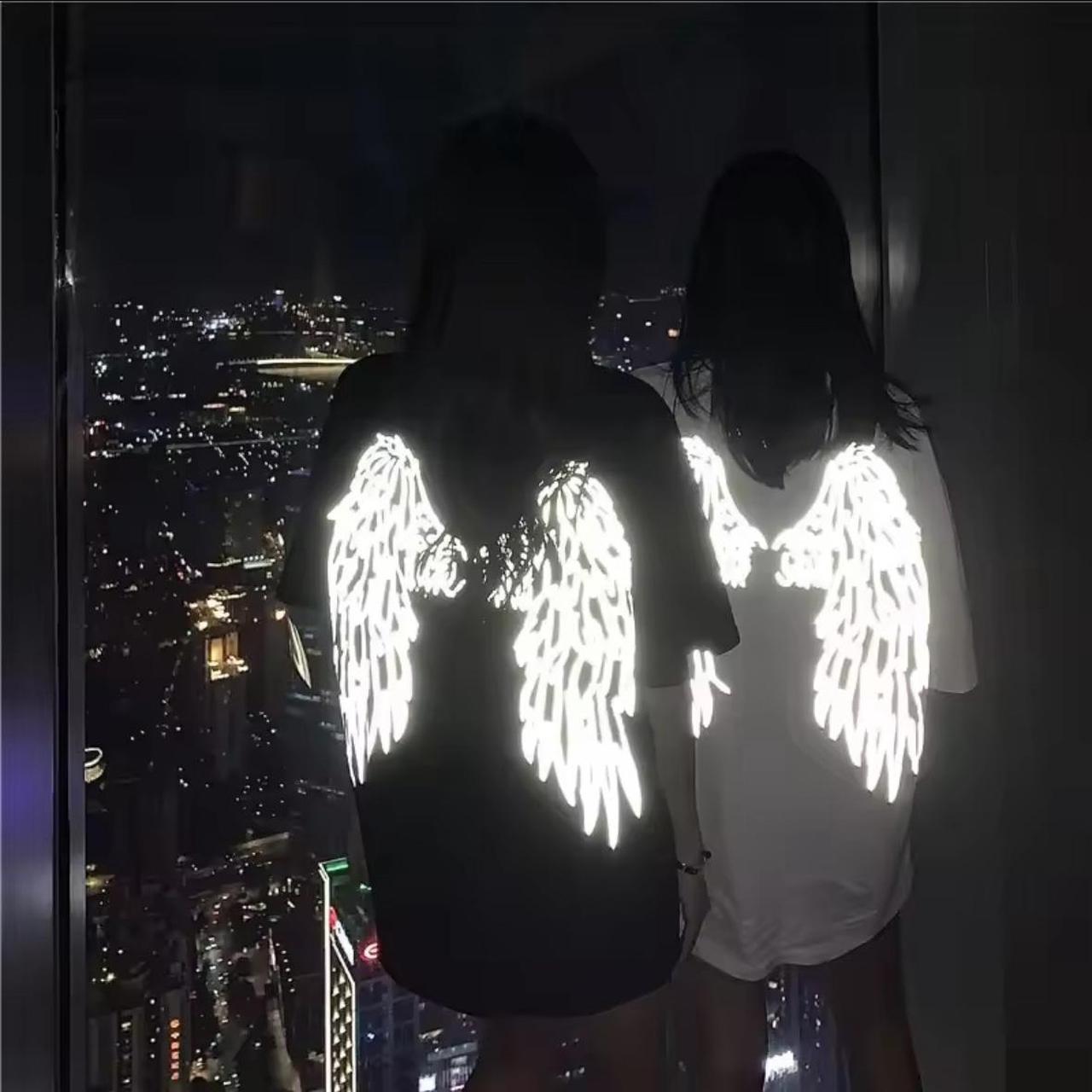 Black Glow reflective Angel wings graphic t-shirt... | Depop