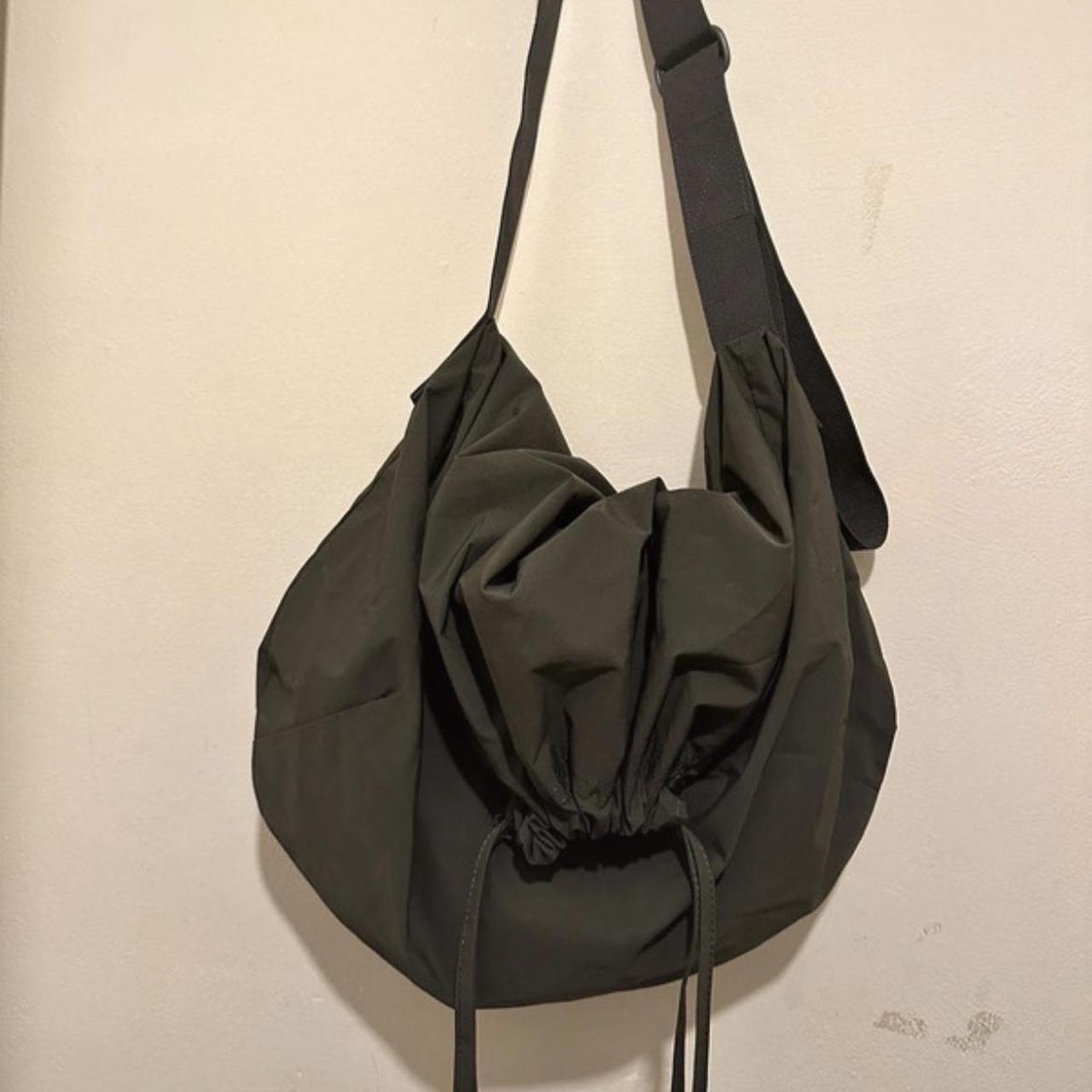 Uniqlo Drawstring Crossbody Bag in Dark green - Depop