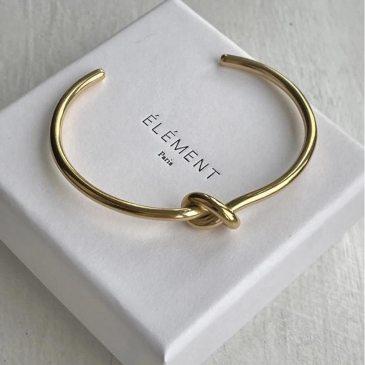 Element knot bangle bracelet in gold 18k gold plated... - Depop