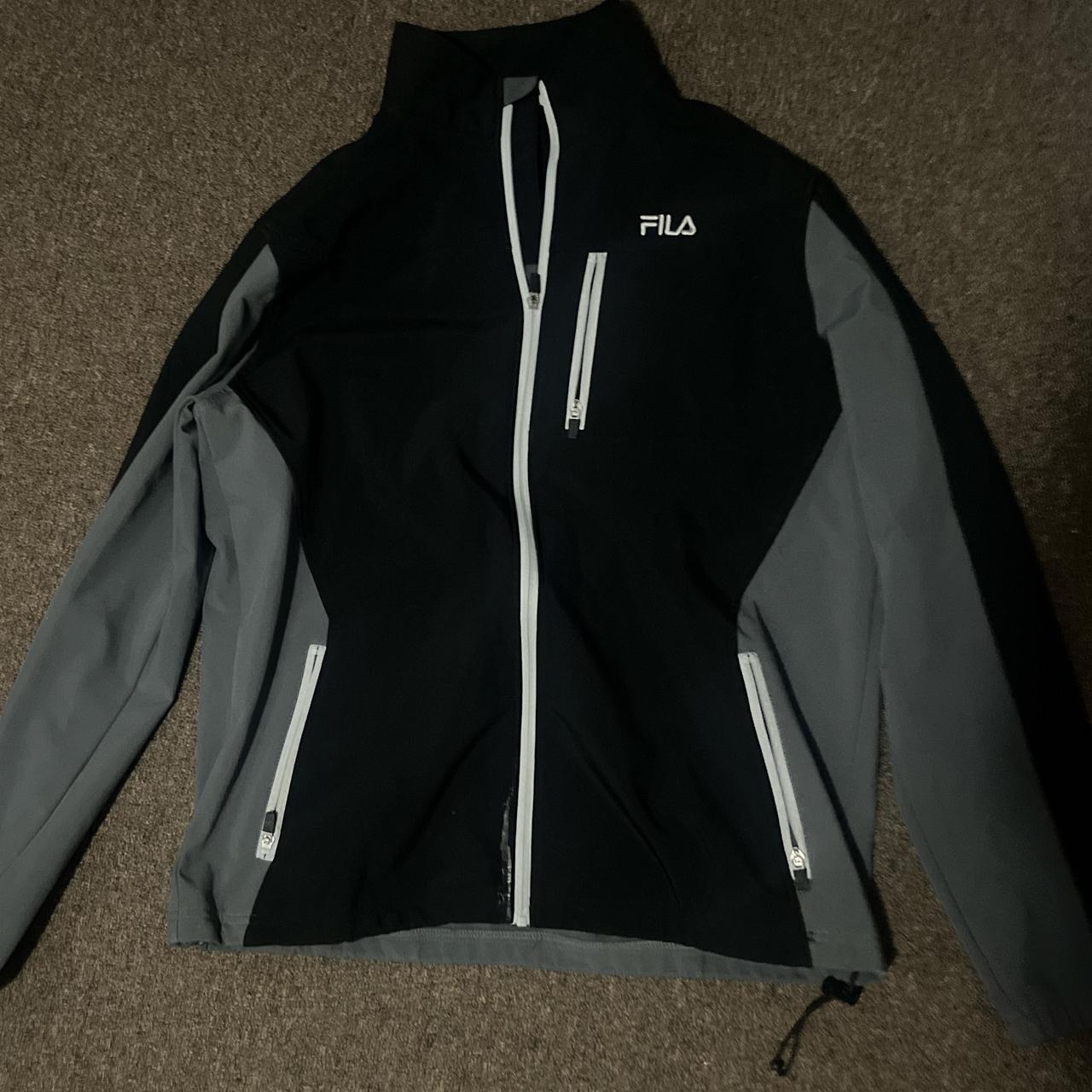 Black and grey Fila jacket with reflective details... - Depop