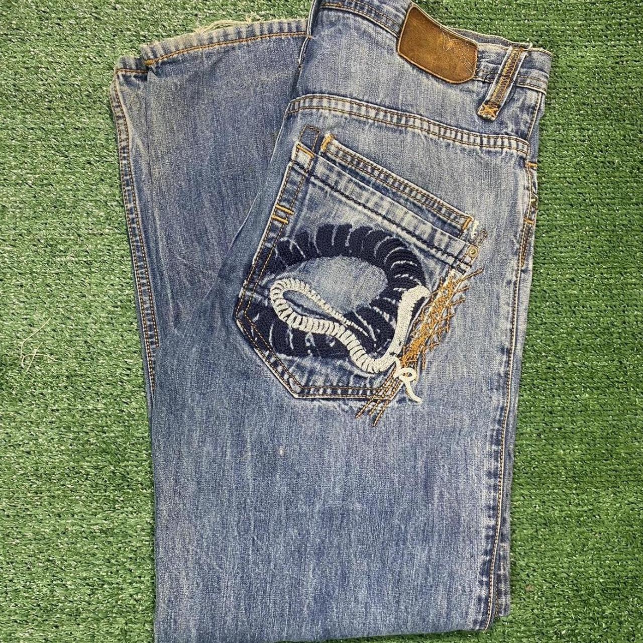 Rocawear Embroidered snake blue jeans with a baggy... - Depop