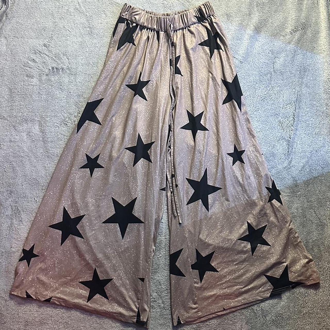 cute black and gold star print flare pants with... - Depop