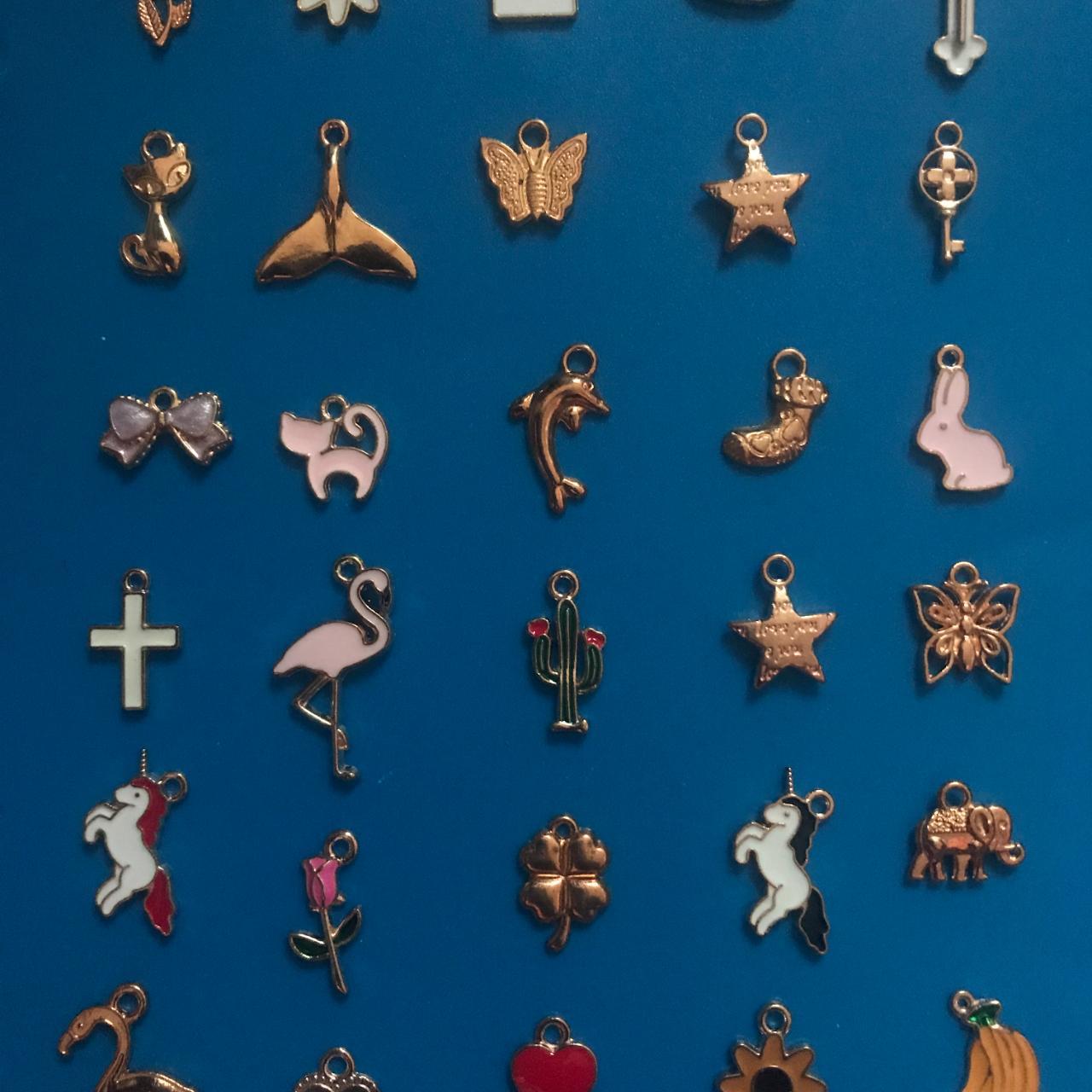 24 Pcs charm pendants. - Depop