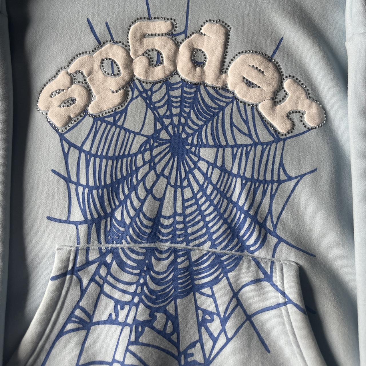 Sky blue rhinestone sp5der hoodie with puff print... | Depop