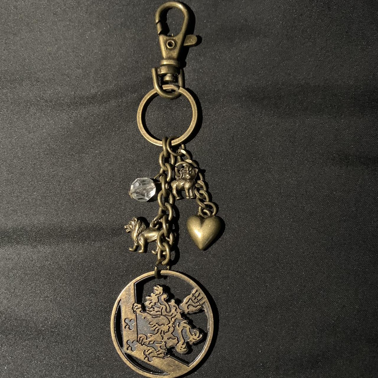 Bronze keychain featuring a lion, cub, heart, charm... | Depop