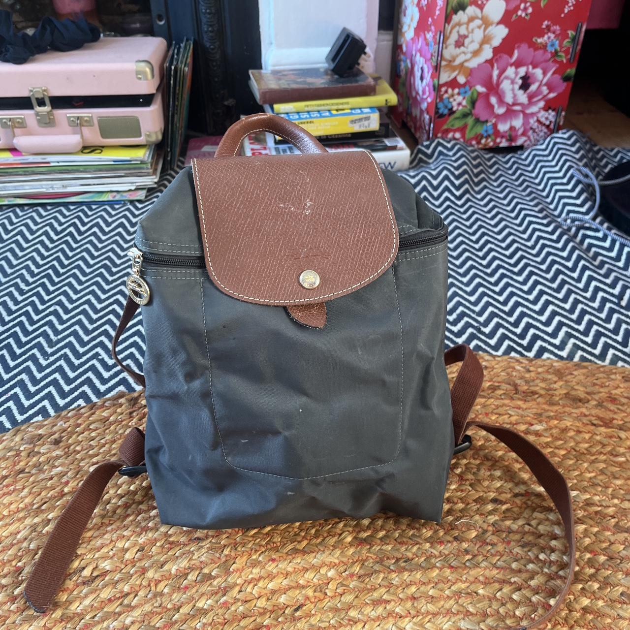 Grey long champ mini back pack, will just about fit... - Depop