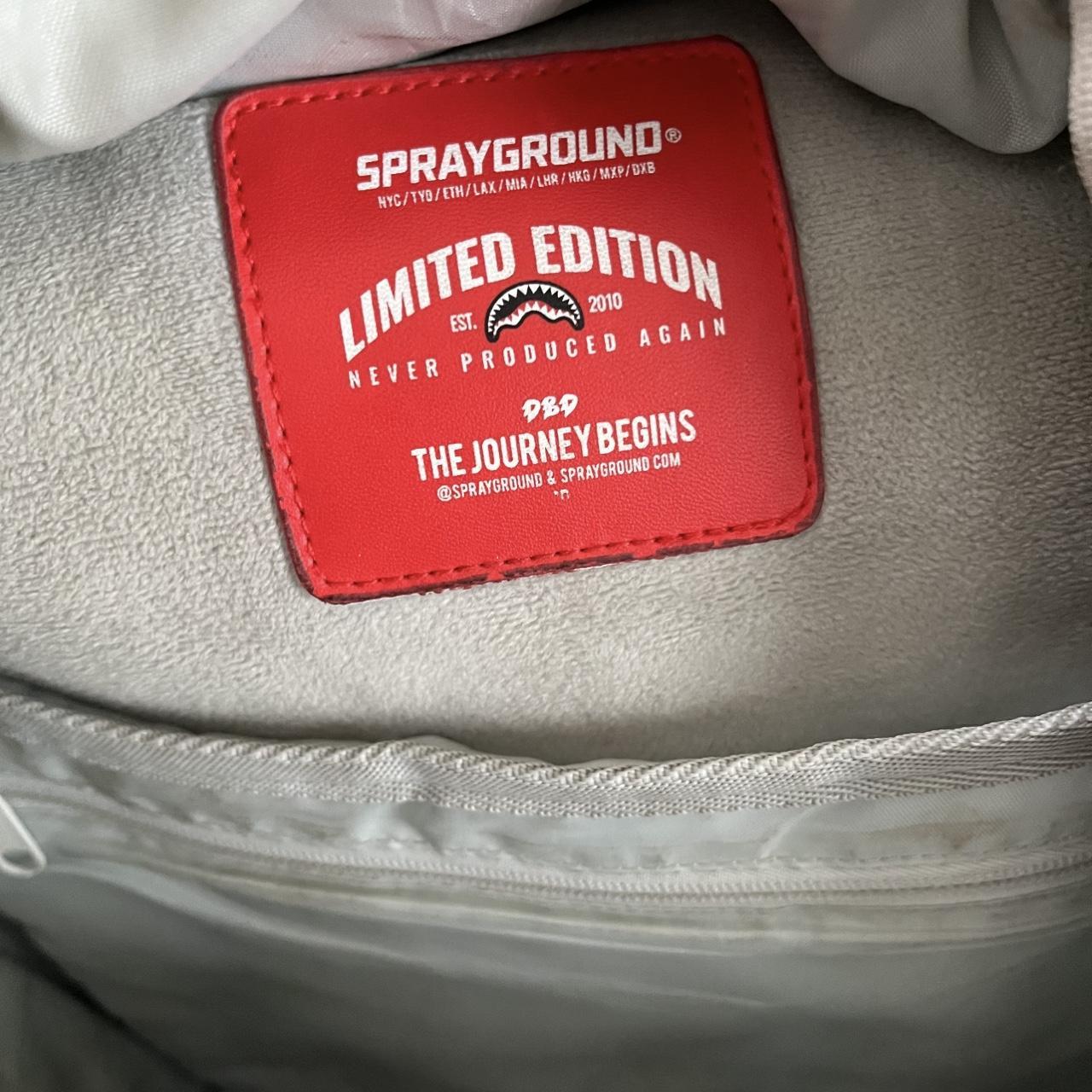 White and pink graffiti sprayground backpack with a... - Depop