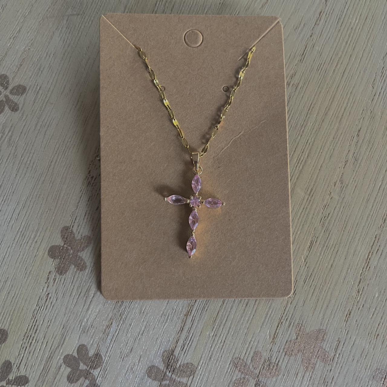 Pink crystal cross necklace on a gold plated chain... - Depop