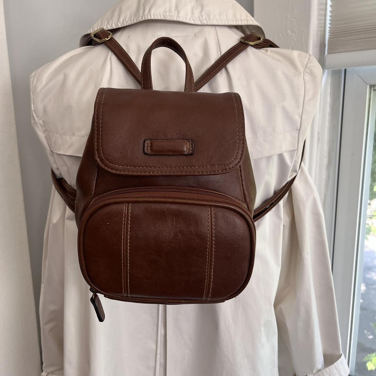 Small brown faux leather backpack with front zipper... - Depop