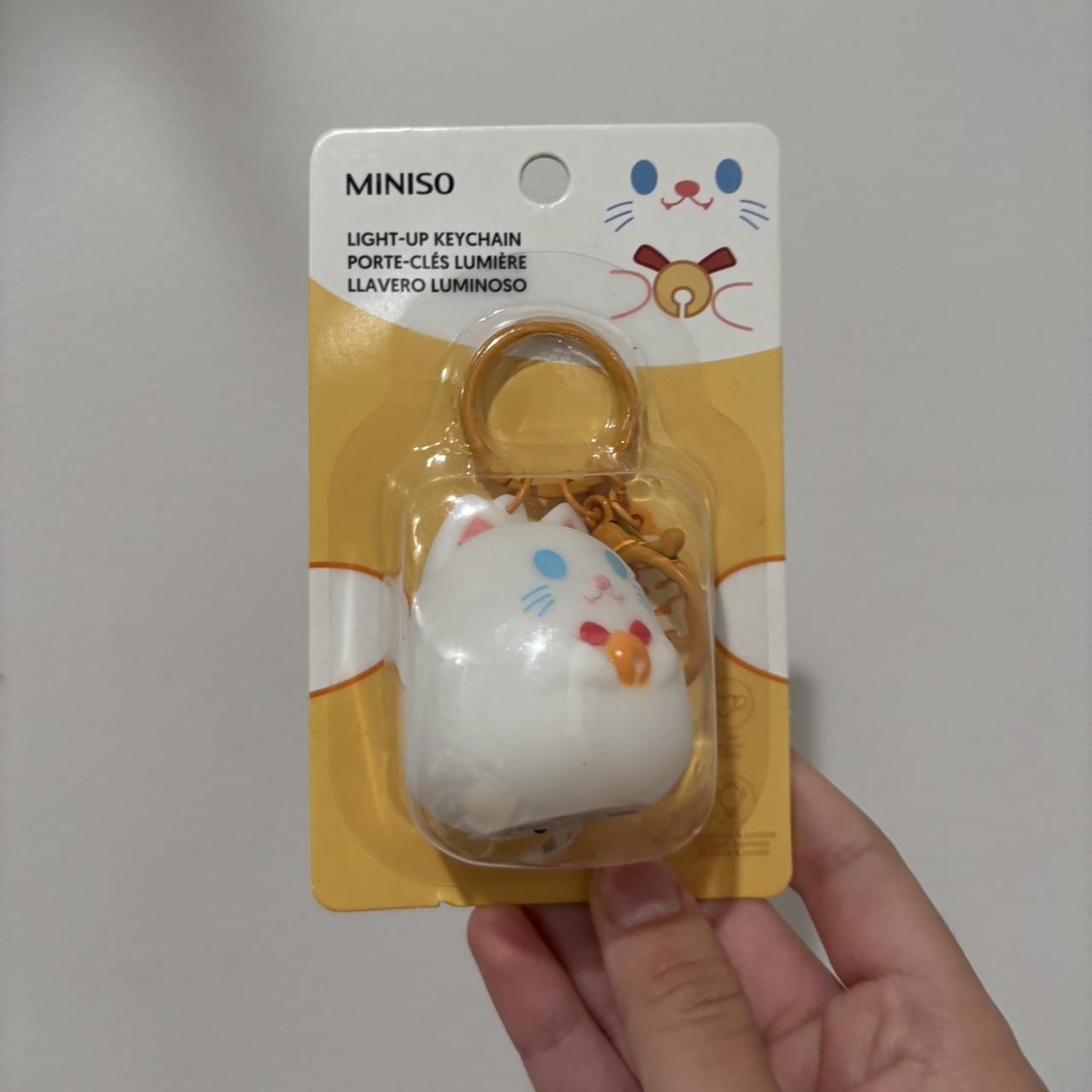 Adorable Miniso cat keychain with a cute design on... - Depop