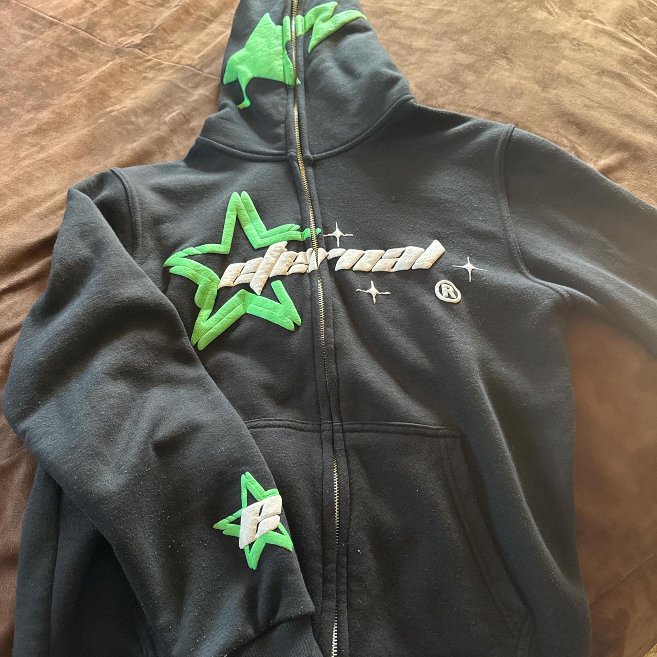 Black and green zip-up hoodie with star design... - Depop
