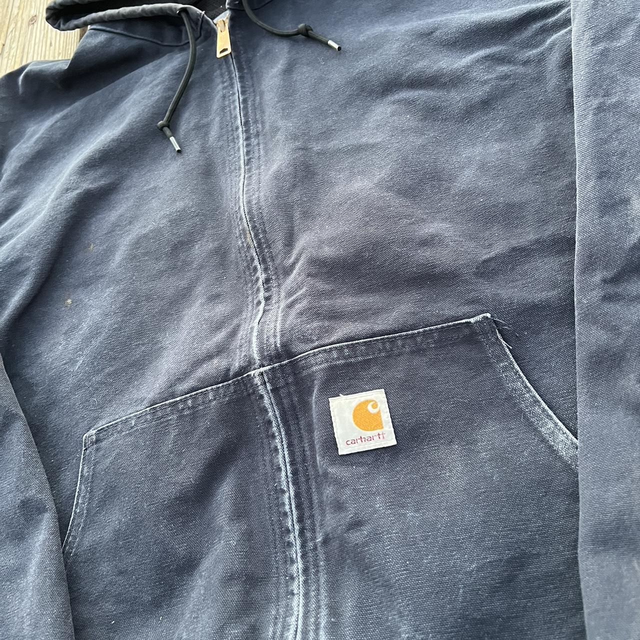 Navy Carhartt jacket with a worn, distressed look - Depop