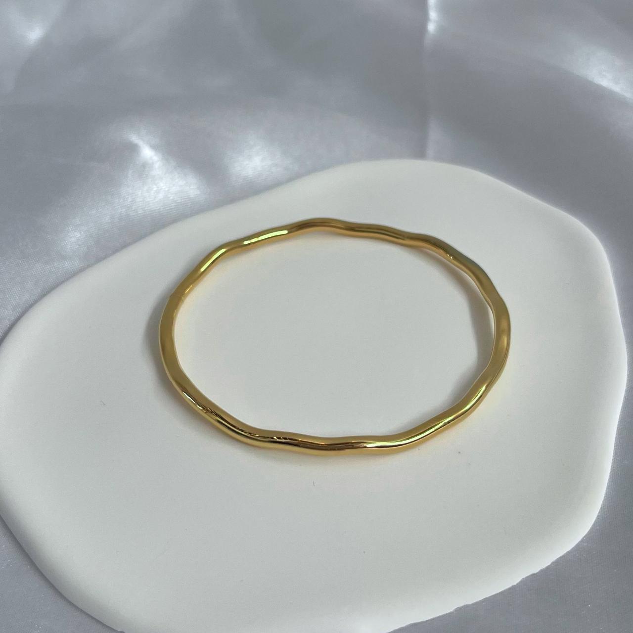 THE IRREGULAR BANGLE A gold bangle with an... - Depop