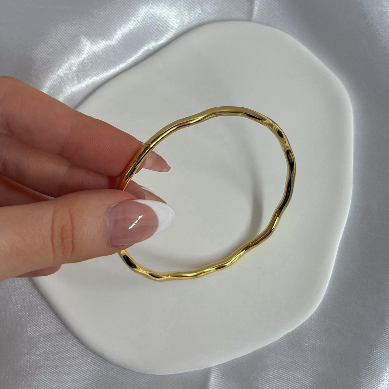 THE IRREGULAR BANGLE A gold bangle with an... - Depop