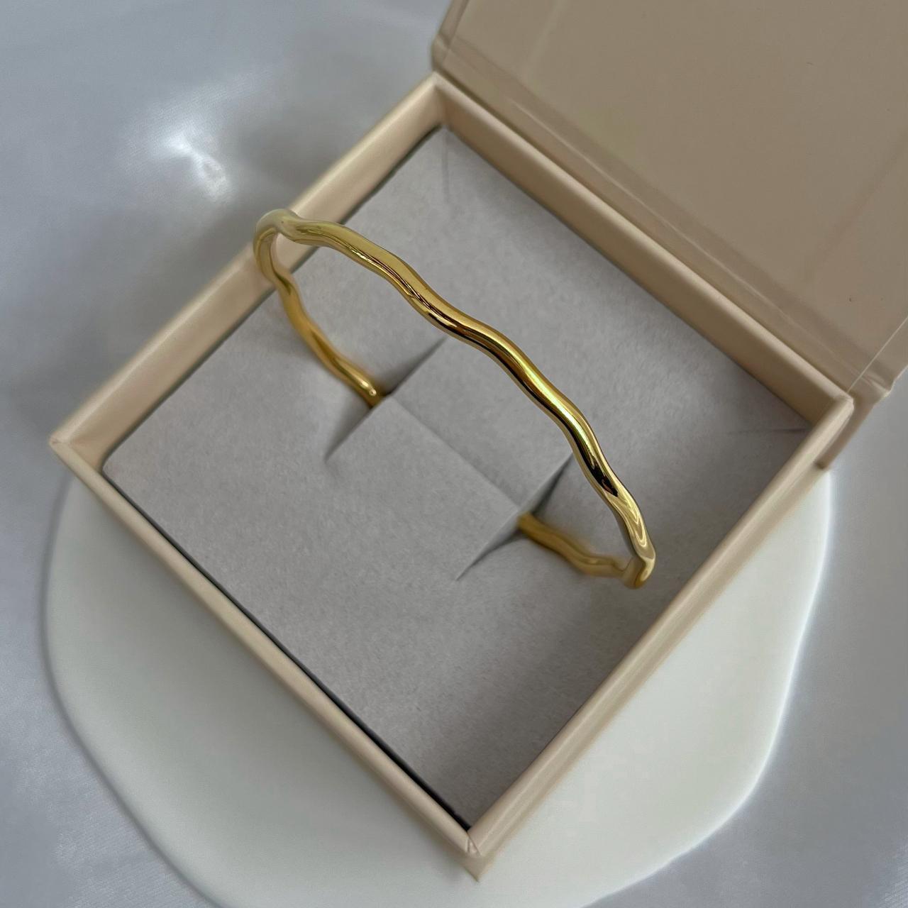 THE IRREGULAR BANGLE A gold bangle with an... - Depop