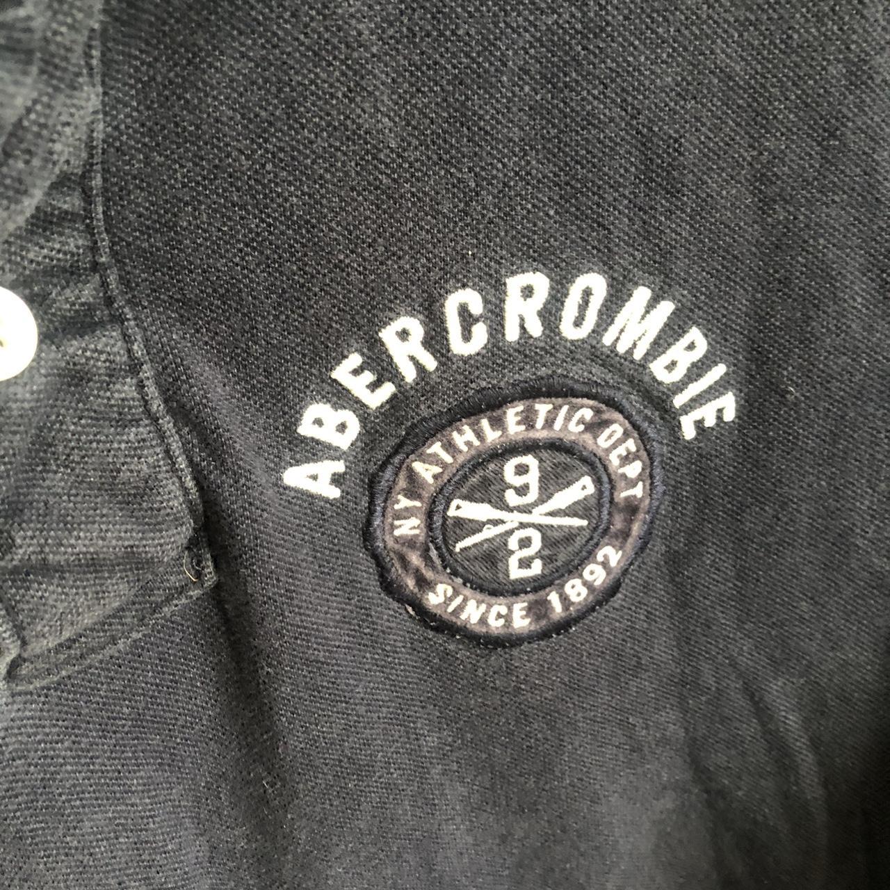 Abercrombie & Fitch Navy Polo Shirt. Slightly faded.... - Depop