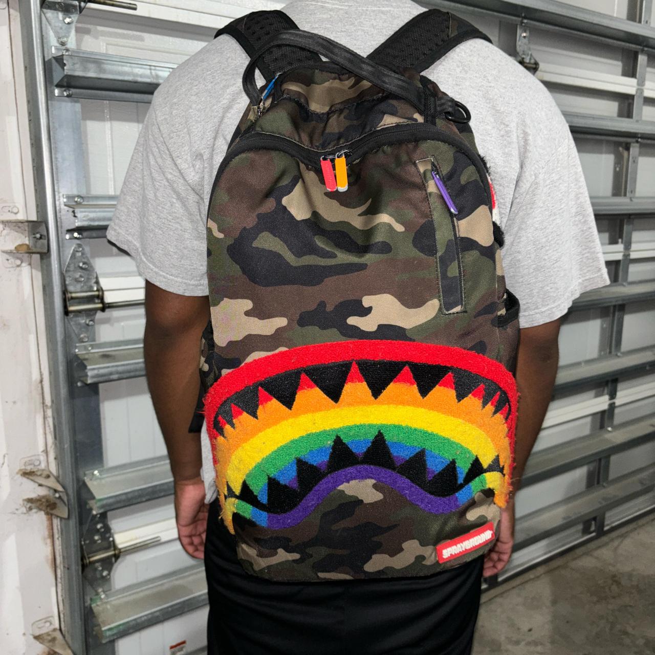 Sprayground Camo backpack with rainbow shark design... - Depop