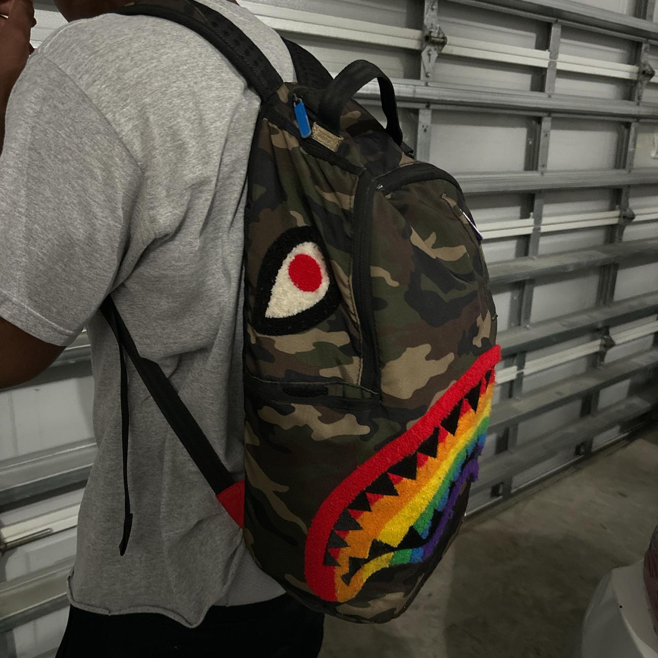 Sprayground Camo backpack with rainbow shark design... - Depop