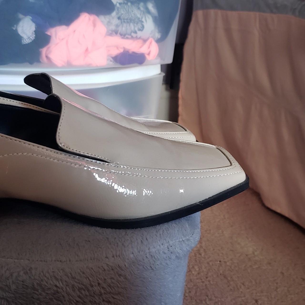Cream colored loafer like shoes. Has a black spot on... - Depop