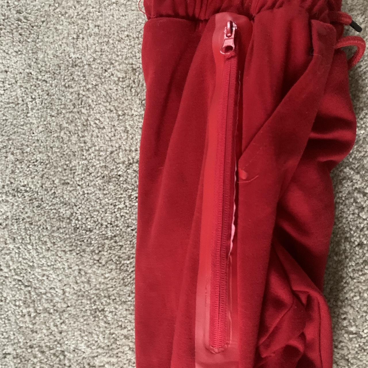 Red nike sweatpants with zip up pockets - Depop
