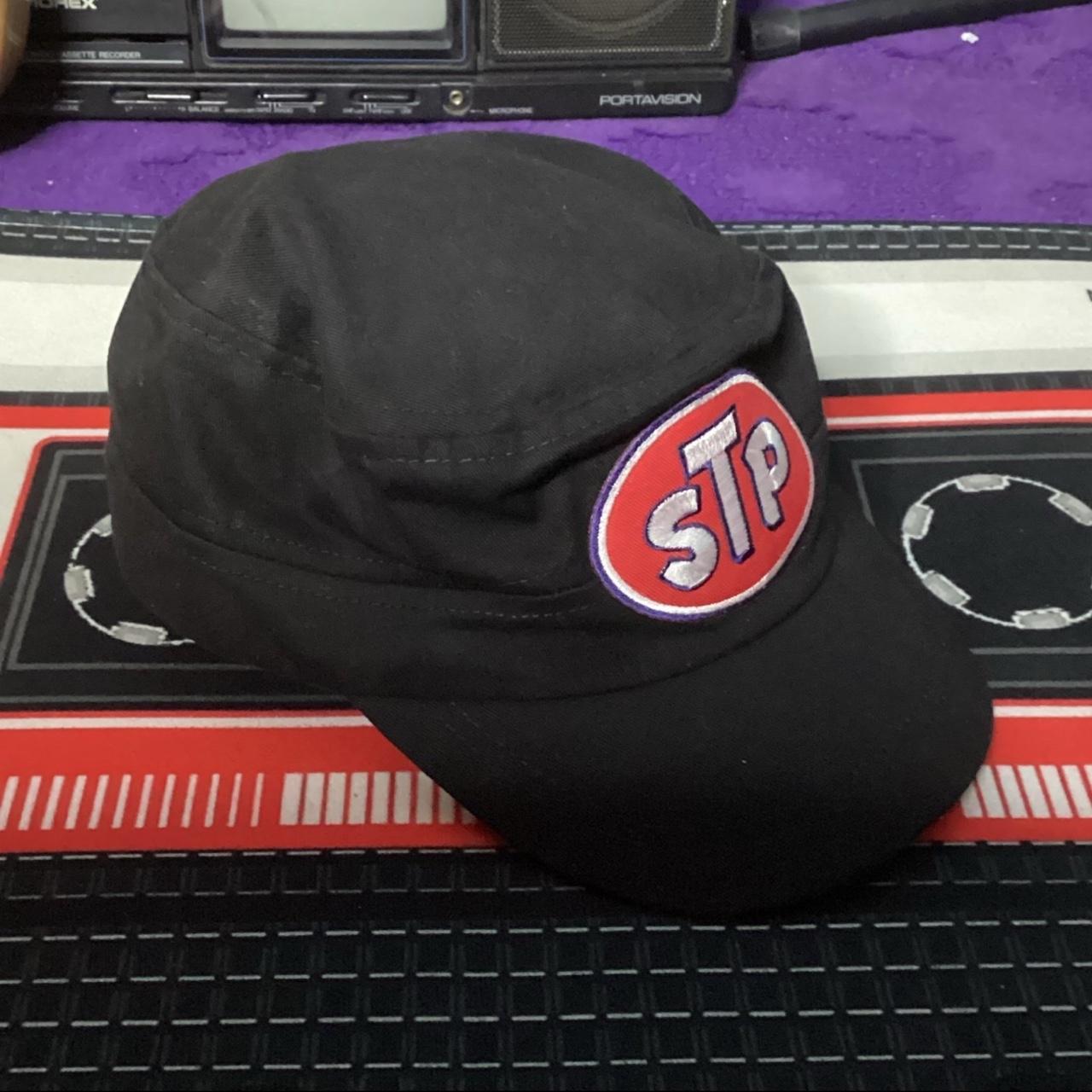 The vintage 90’s style black hat has the STP logo... | Depop
