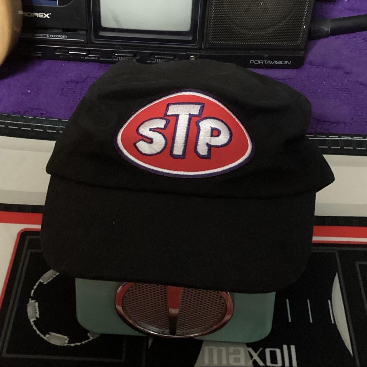 The vintage 90’s style black hat has the STP logo... | Depop
