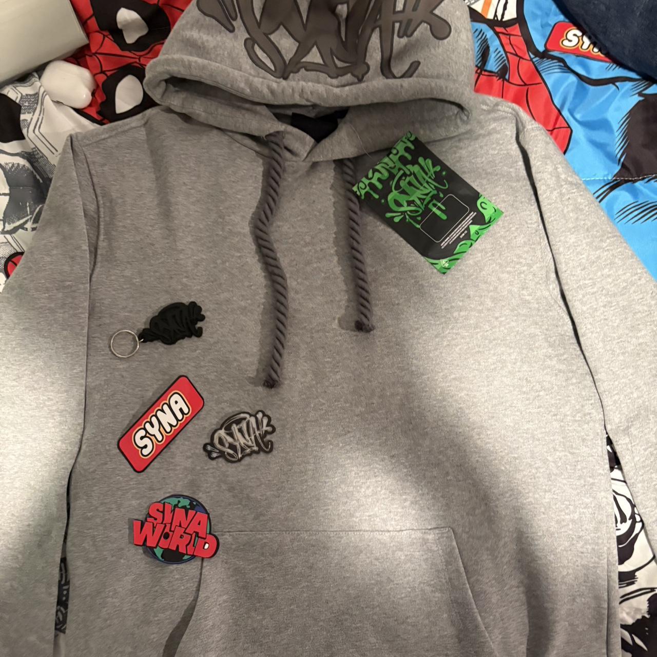 Grey Syna world hoodie with keychain and stickers... - Depop