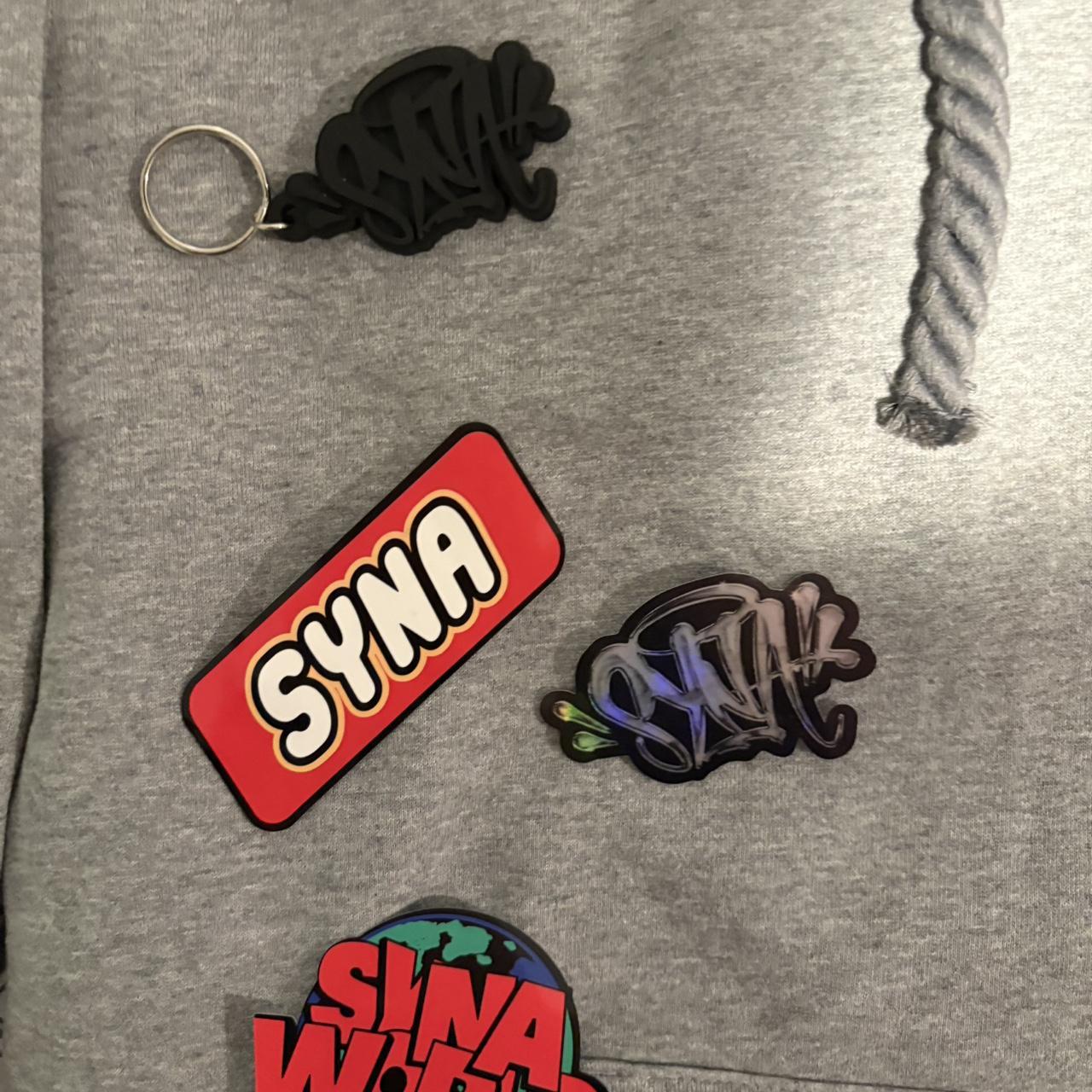 Grey Syna world hoodie with keychain and stickers... - Depop