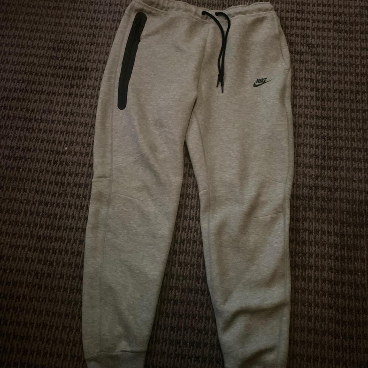 Grey Nike tech pants size large fits medium worn... - Depop