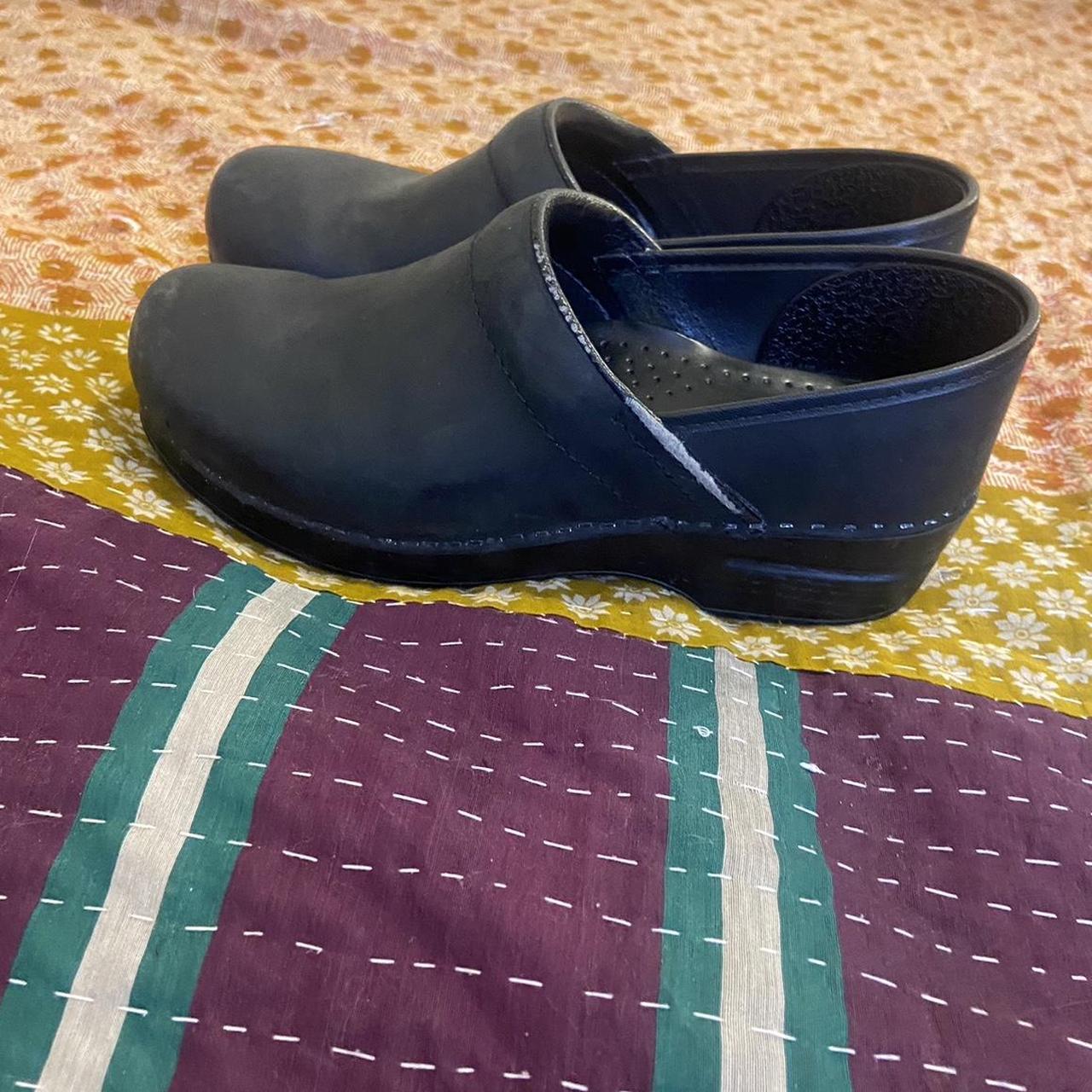 Black leather Dansko clogs with wear along the trim... - Depop