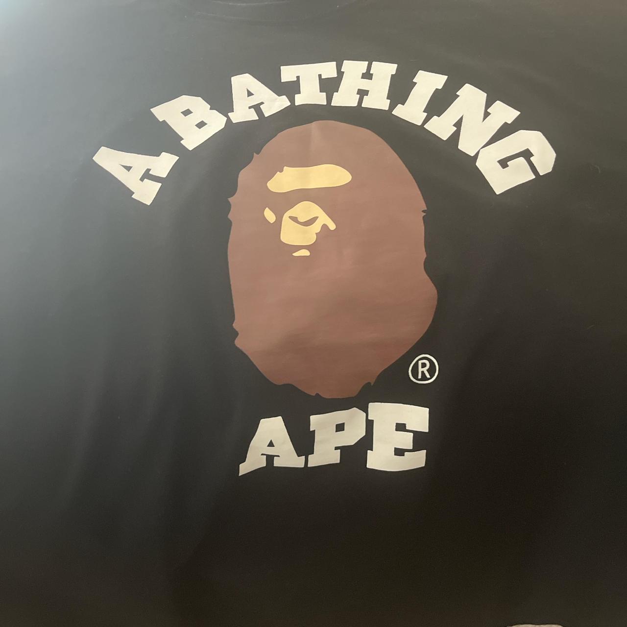 L black bape shirt with a big neck opening and tag... - Depop