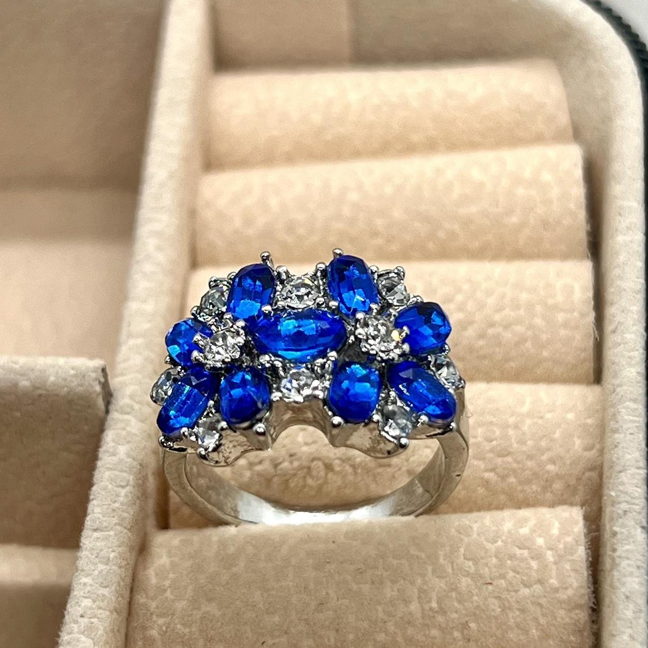 Silver colour ring with blue and white stones Size... - Depop