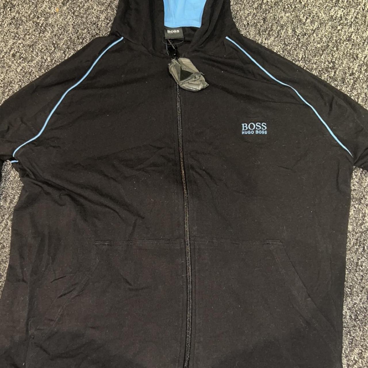 Hugo Boss zip-up hoodie in black with blue piping... | Depop