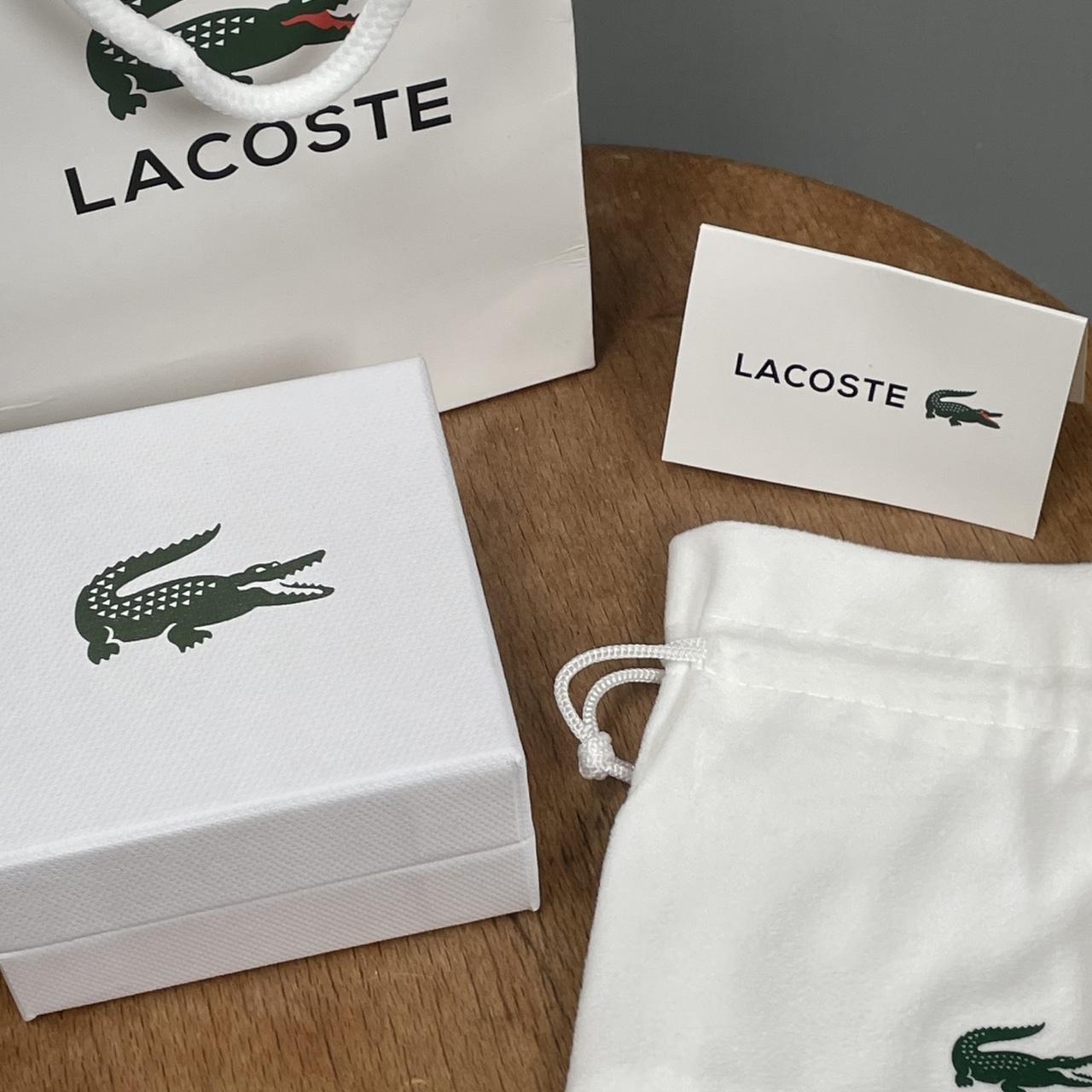 Lacoste gold tone stainless steel bracelet... | Depop