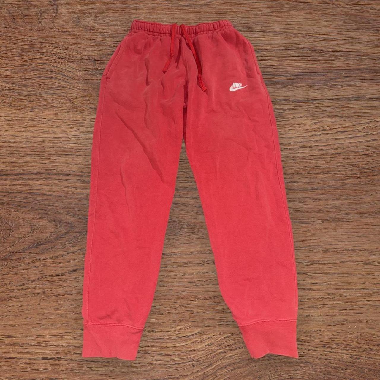 Red Nike sweatpants with embroidered logo,... | Depop
