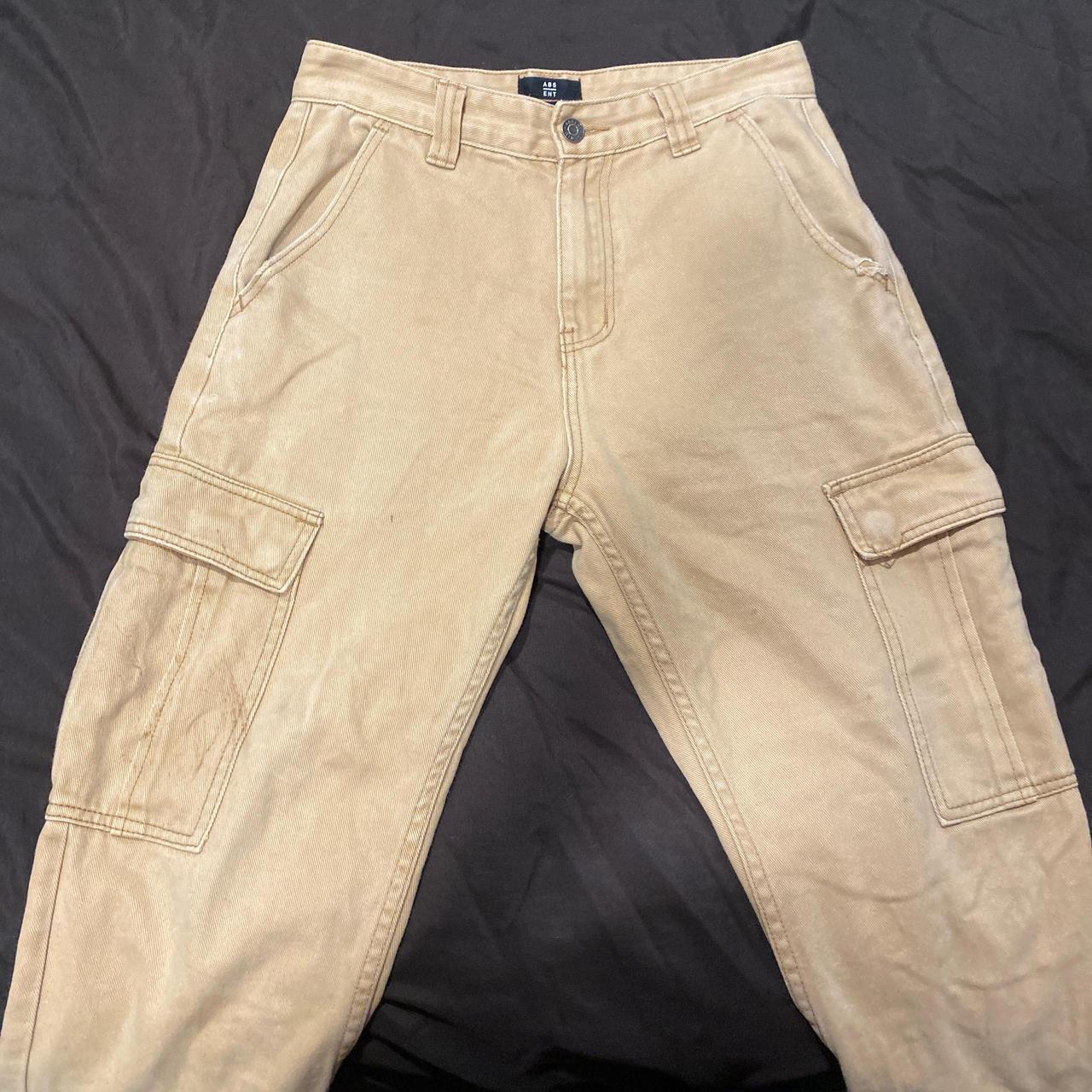 Tan cargo pants with a baggy fit. Absent brand - Depop