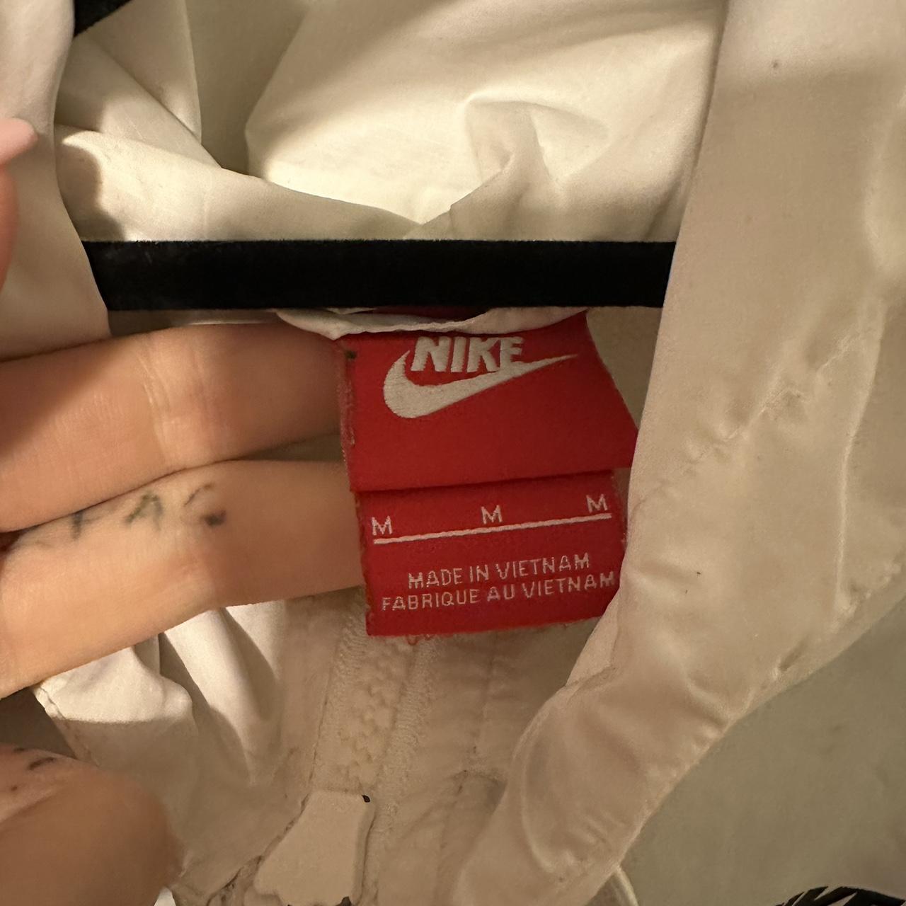 Black and white Nike wind sheeter, few small holes. - Depop