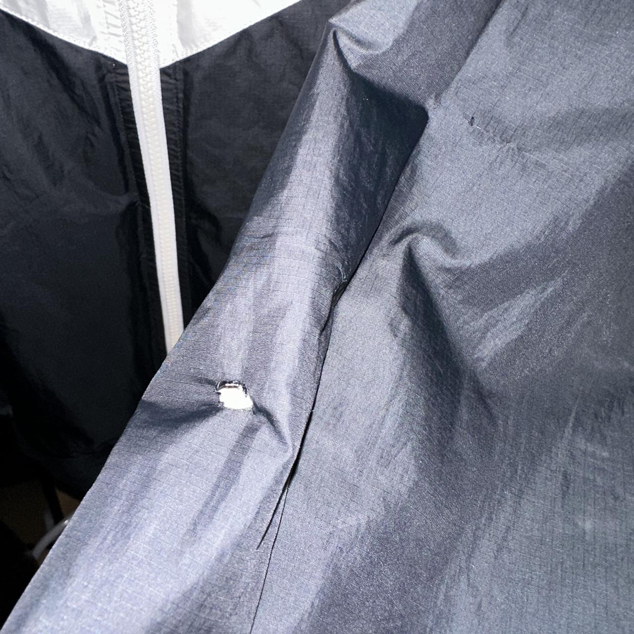 Black and white Nike wind sheeter, few small holes. - Depop