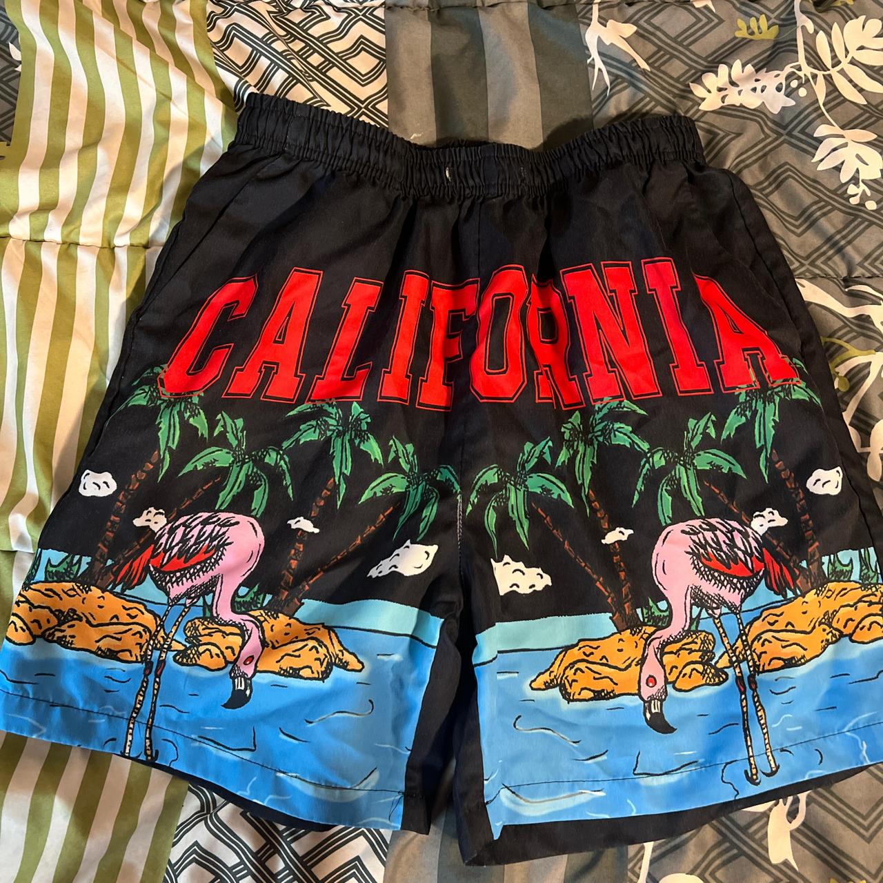 California Flamingo black and red swim trunks #flamingo - Depop