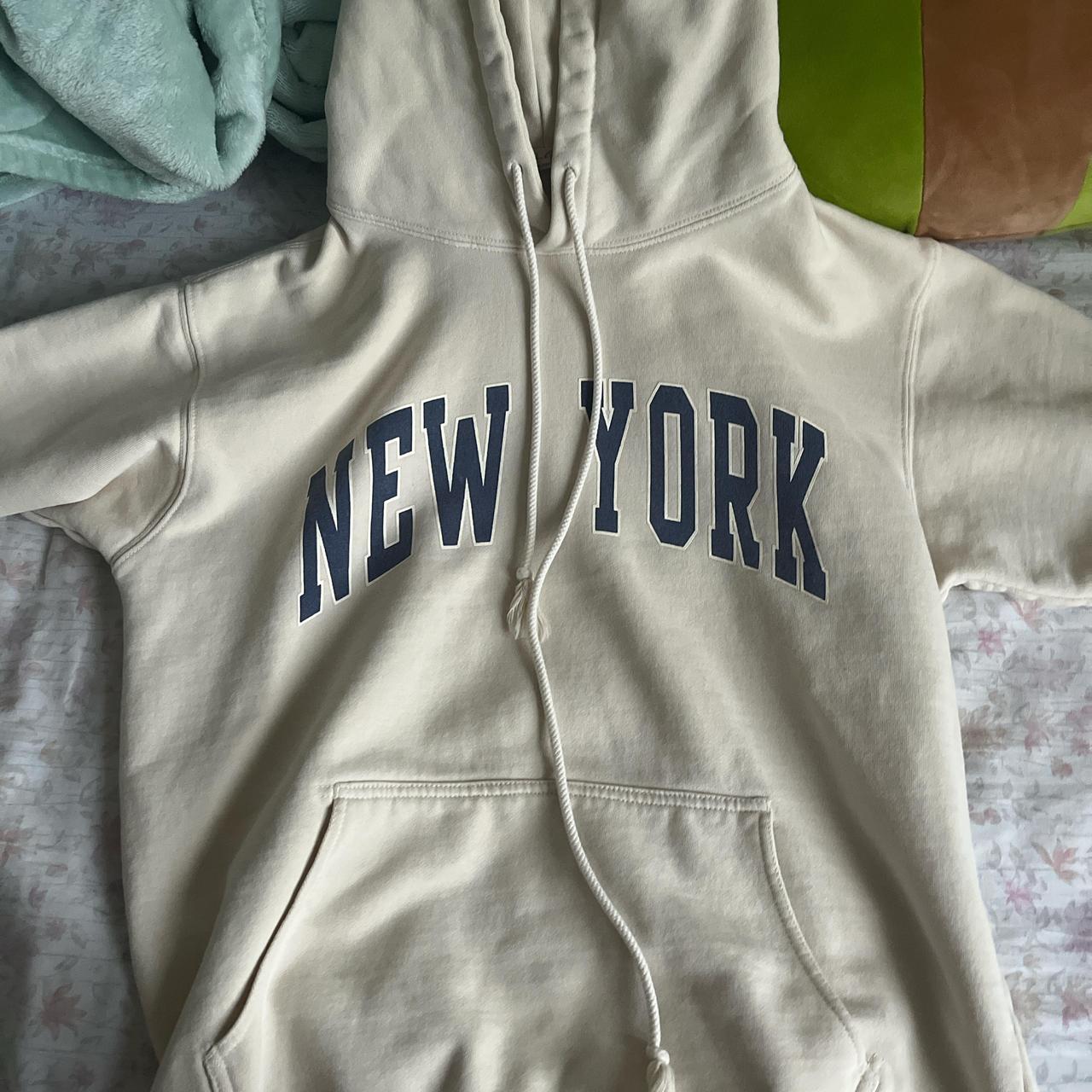 Cream colored hoodie with navy words Rarely... - Depop