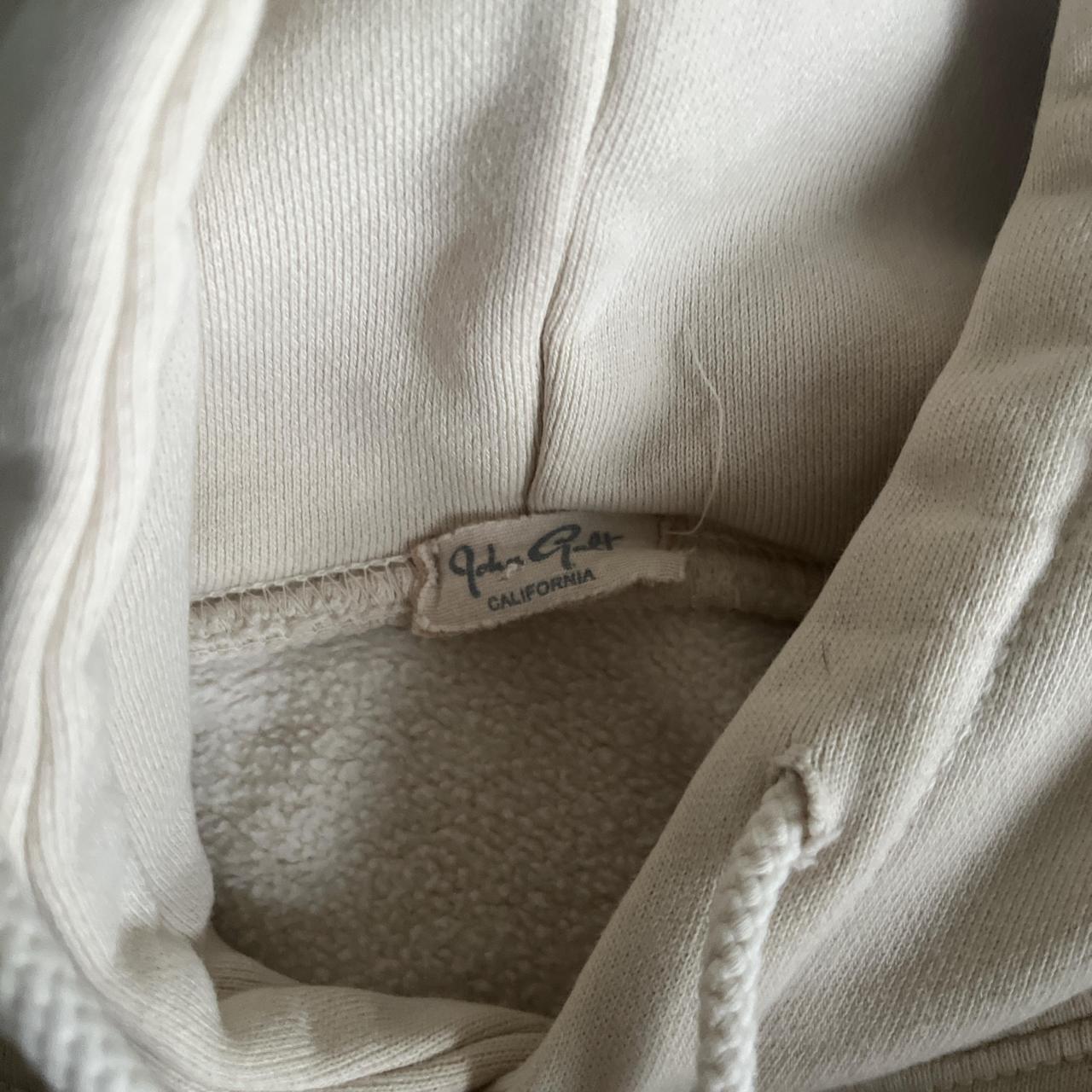 Cream colored hoodie with navy words Rarely... - Depop