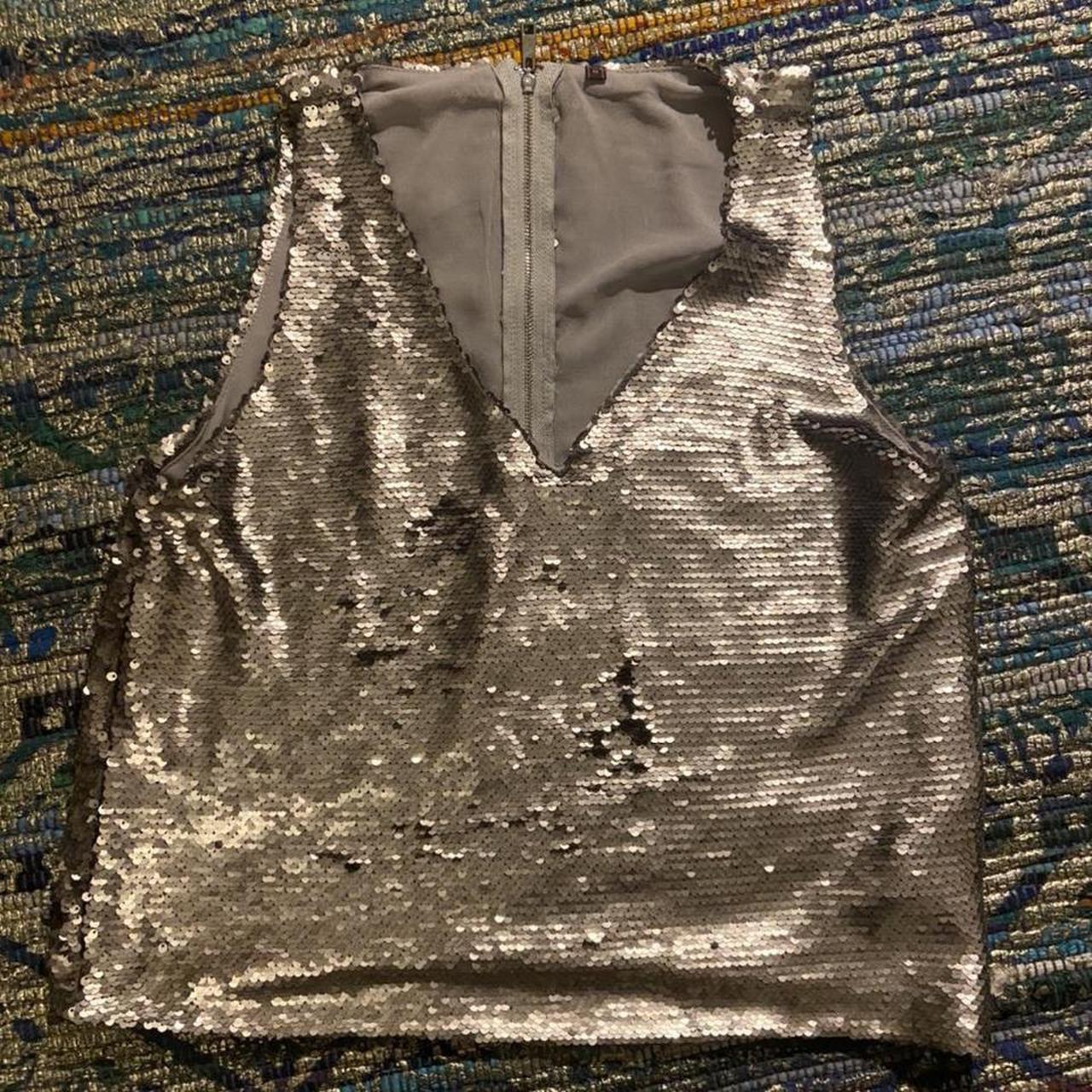 Lovely silver sequin top. Deep V-neck, nice on... - Depop