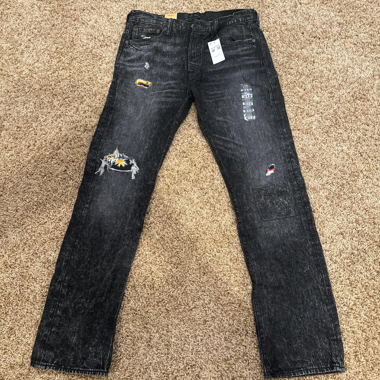 Levi s black denim jeans with patches and rips