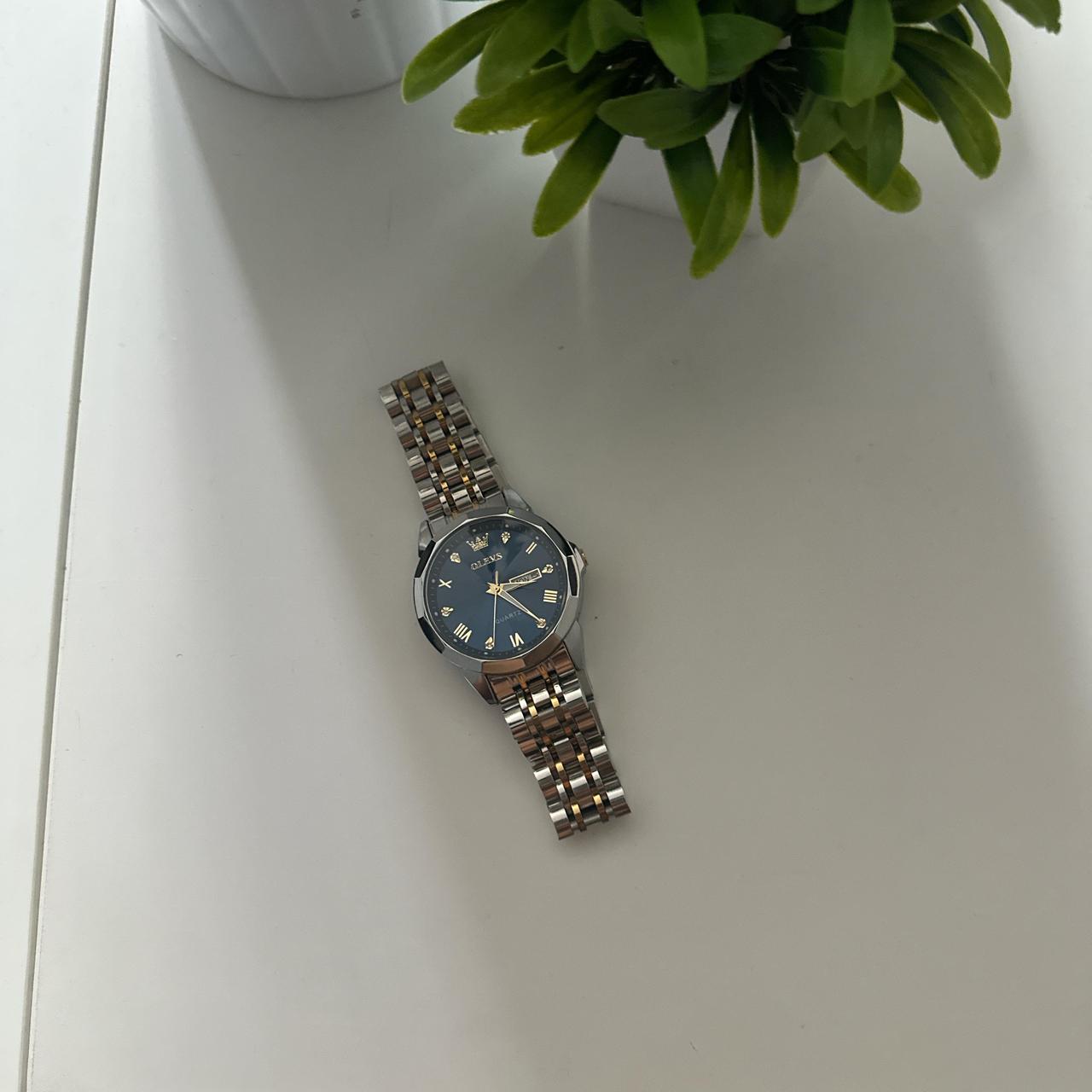 Blue faced Olves watch, with gold accents on the... | Depop