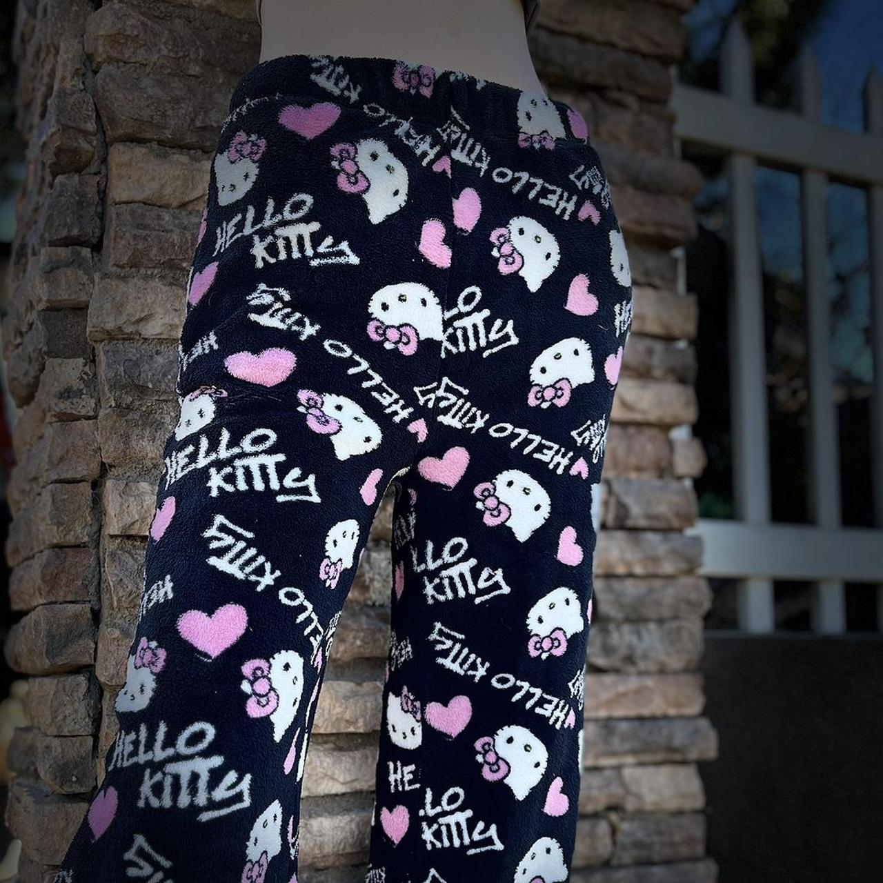 Black Hello Kitty flare pants with pink hearts.... - Depop