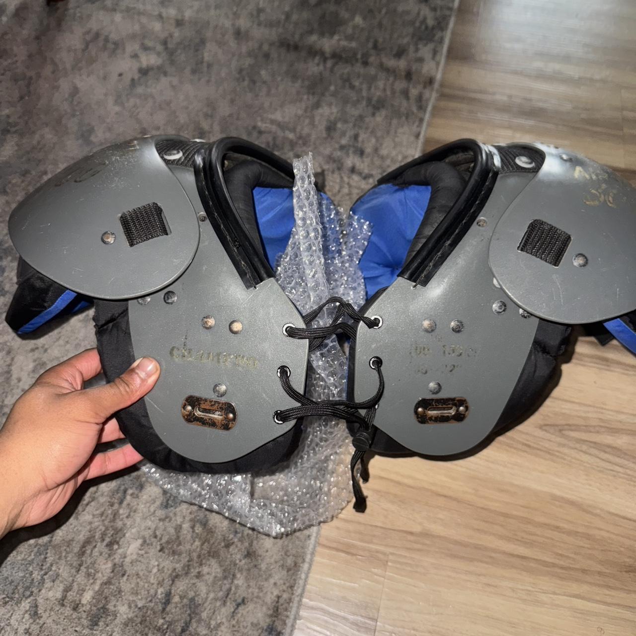 Grey and blue shoulder pads for football... | Depop