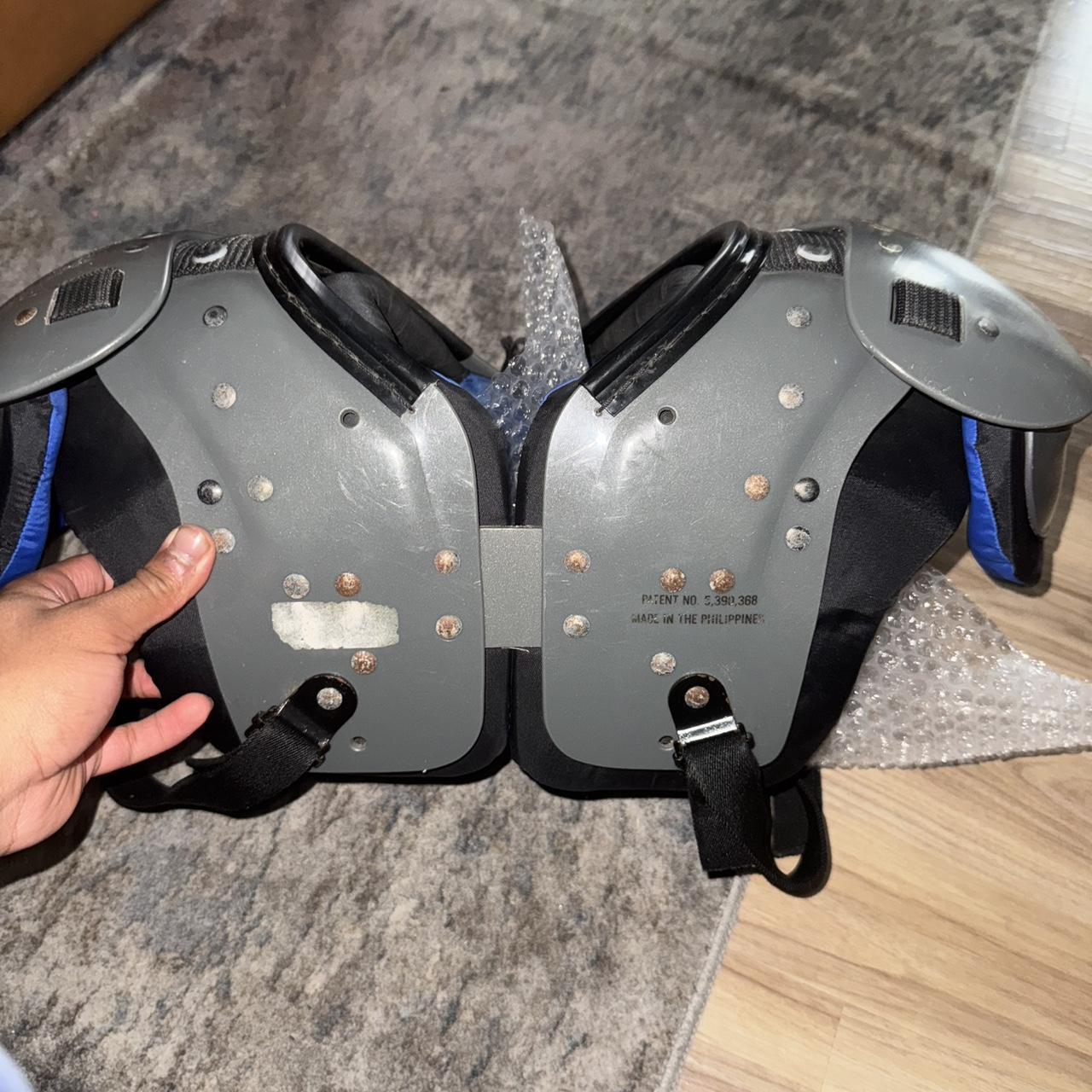 Grey and blue shoulder pads for football... | Depop