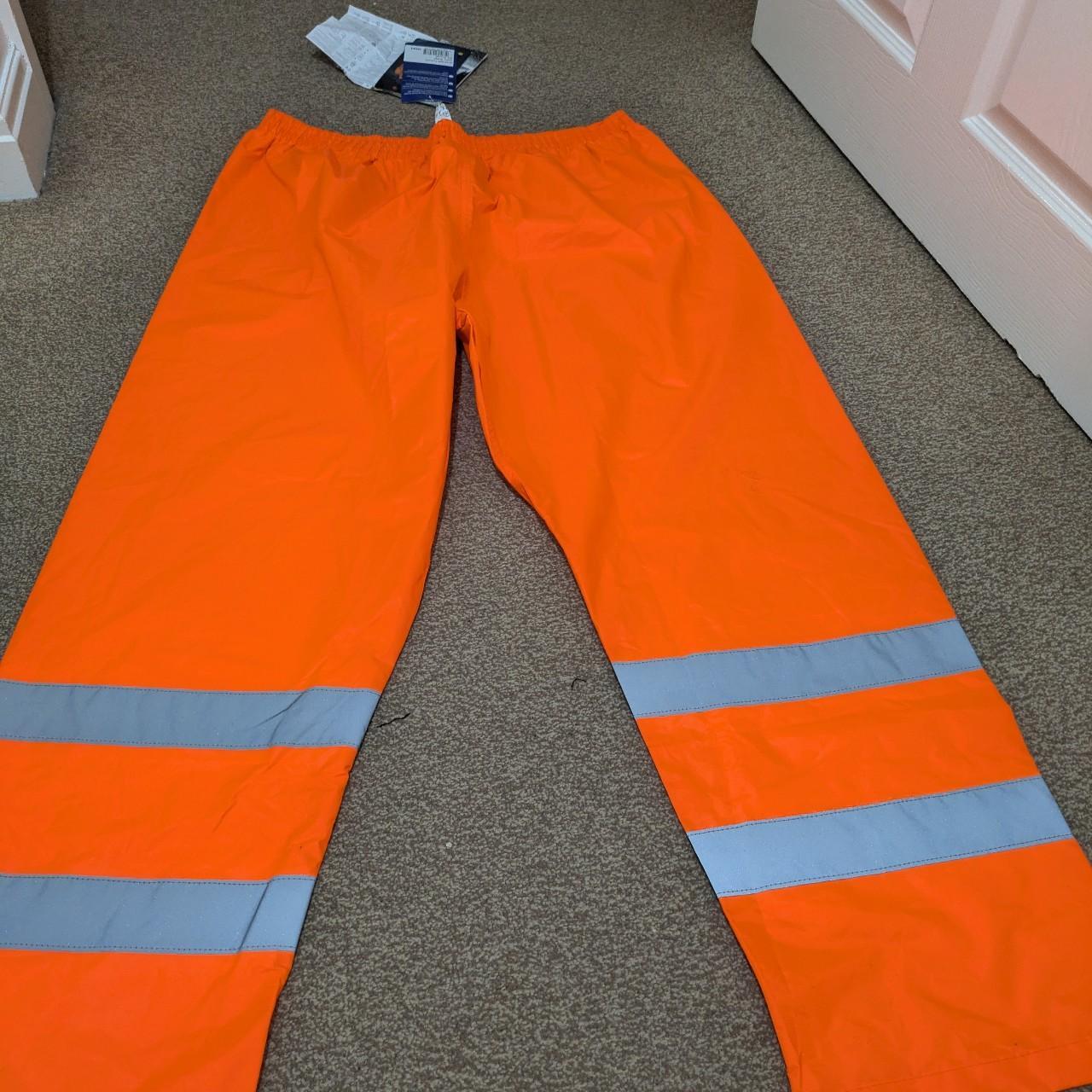 Orange waterproof trousers with reflective stripe,... | Depop